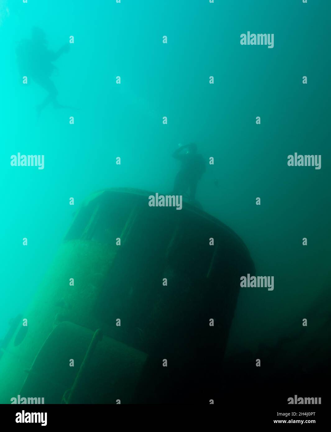 Diver saluting while on a tugboat shipwreck in Lake Superior Stock ...