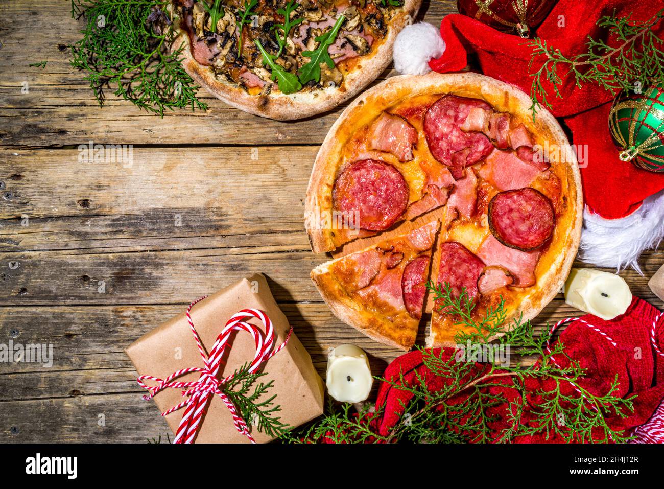 Christmas decorated background with pepperoni and mushrooms pizza ...