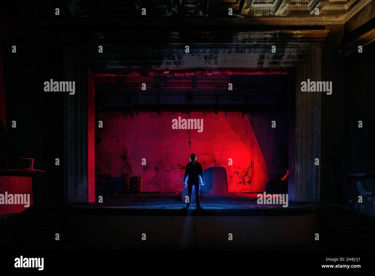 Man on the stage of creepy abandoned theater Stock Photo - Alamy