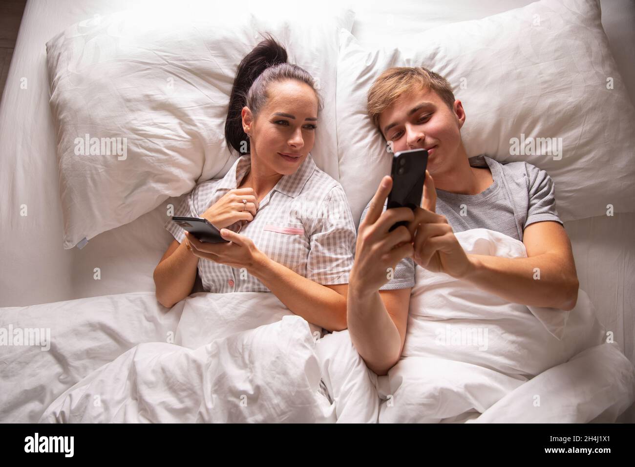 Top view of a couple sharing interesting and funny things on their ...