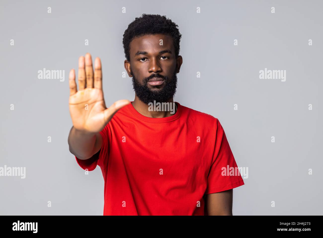 African man showing stop sign with hand over white background Stock ...