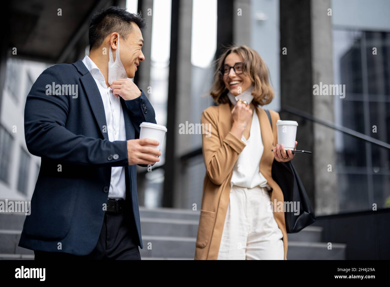 Colleagues walking and talking in city hi-res stock photography and ...
