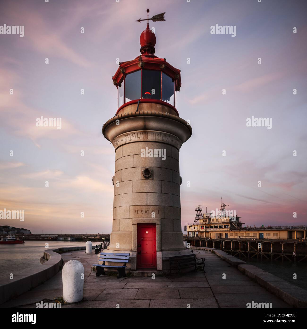 Dominant Ramsgate granite lighthouse located at the end of the port sea ...