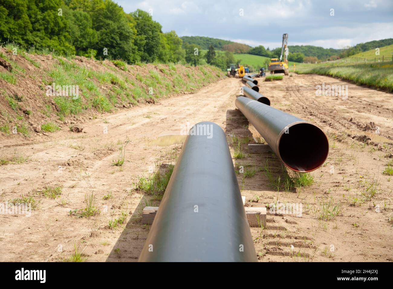 Gas pipes are shown in large format in a country side with pipe laying ...