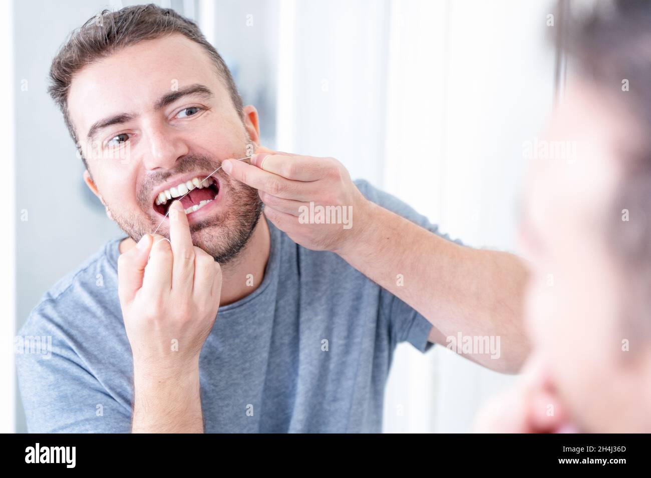 Man dental floss cleaning teeth hi-res stock photography and images - Alamy