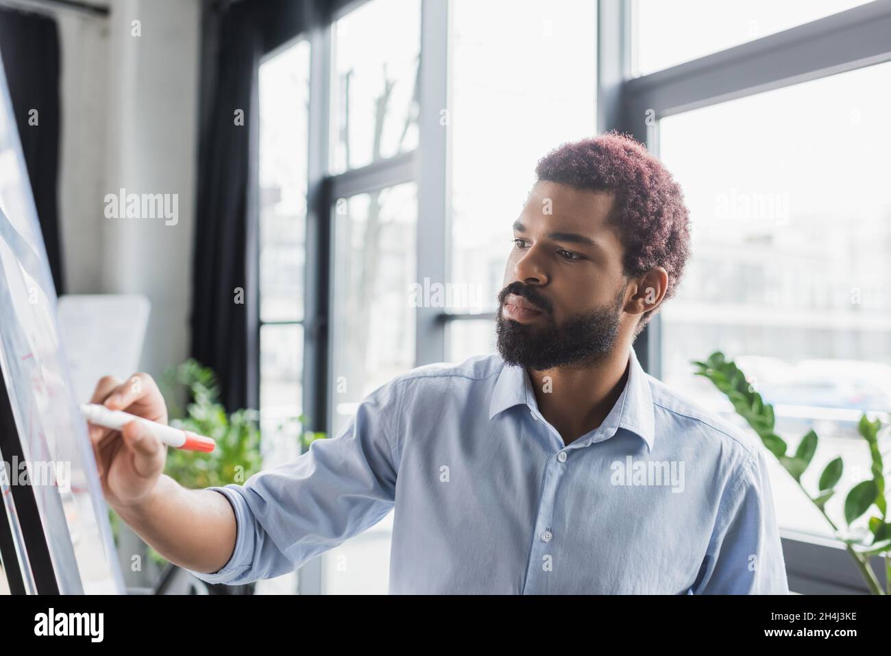 African american manager writing on glass board in office Stock Photo ...