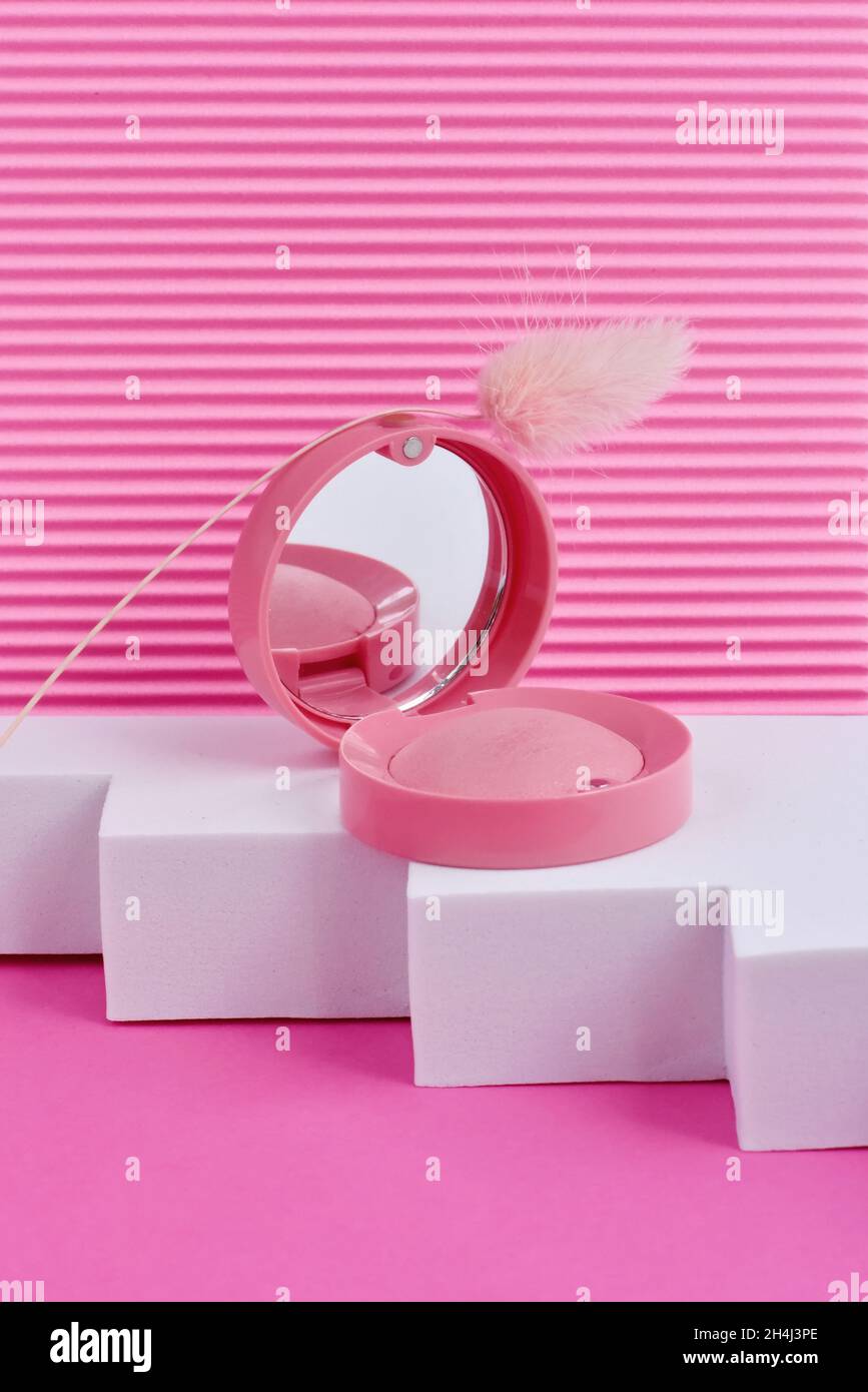 Round Blush in pink box with mirror on podium on a pink background ...