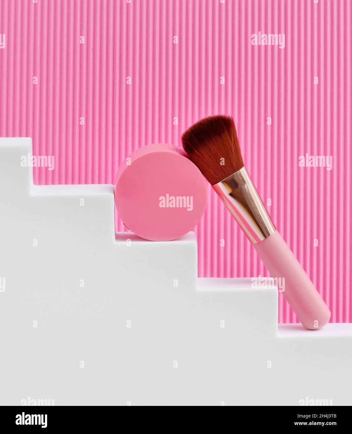 Round Blush in pink box with make-up brush on staircase podium ...