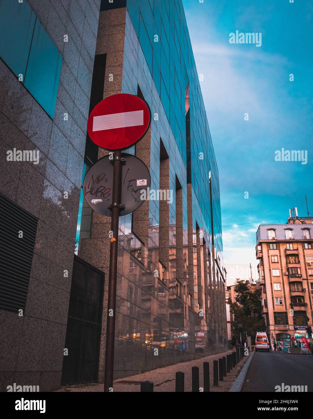 BUCHAREST, ROMANIA - Sep 01, 2021: A traffic sign against a glass ...