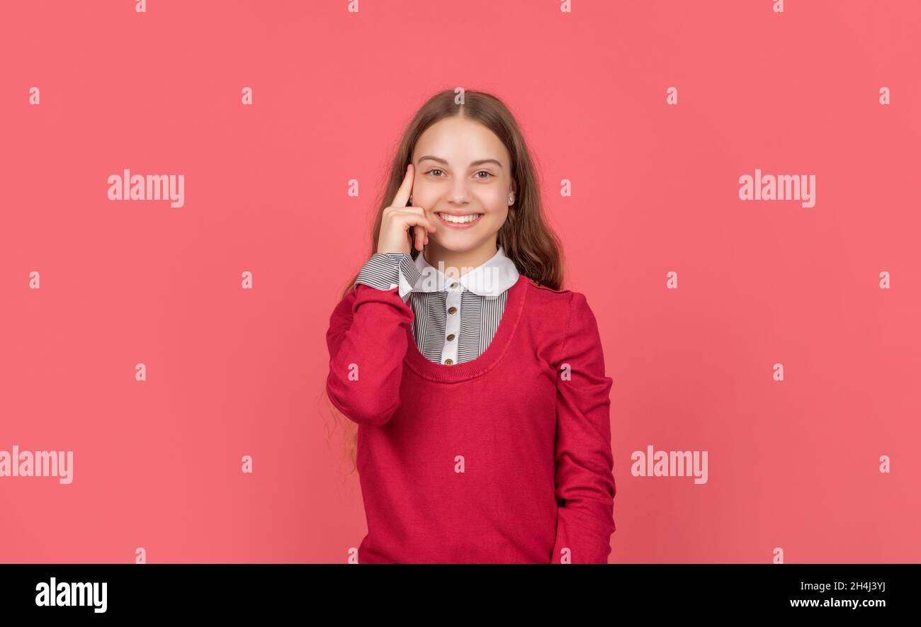 pondering happy kid in school uniform on red background, student Stock ...