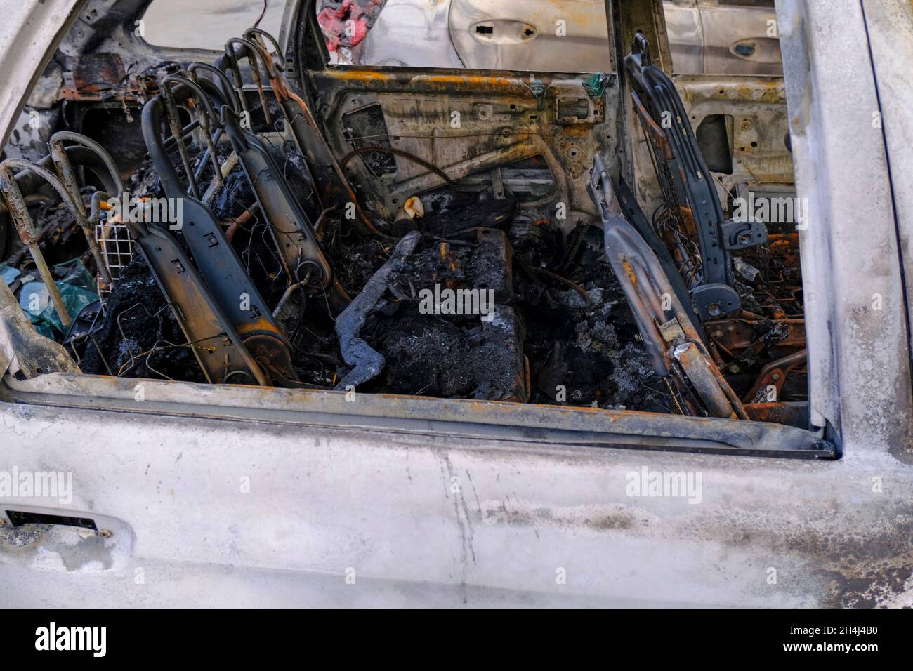 broken car's interior wreck. Burnt car's seats in the street. Riot ...