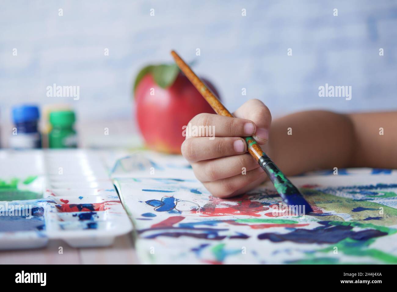 child girl drawing on paper with art brush Stock Photo - Alamy
