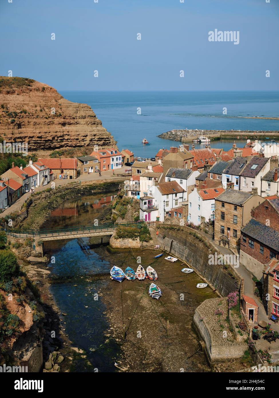 Staithes harbour and beck at low tide in the popular fishing village in ...
