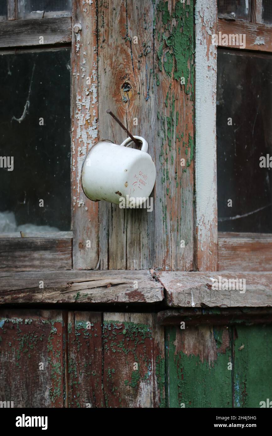 Enamel cup hanging on a nail outside an abandoned house in Chernobyl ...