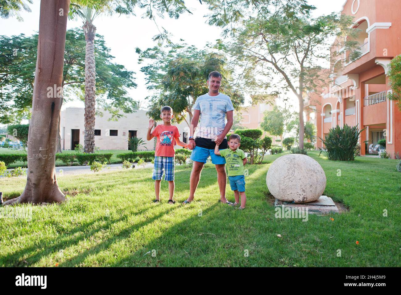 Father with two sons at garden of egyptian resort Stock Photo - Alamy