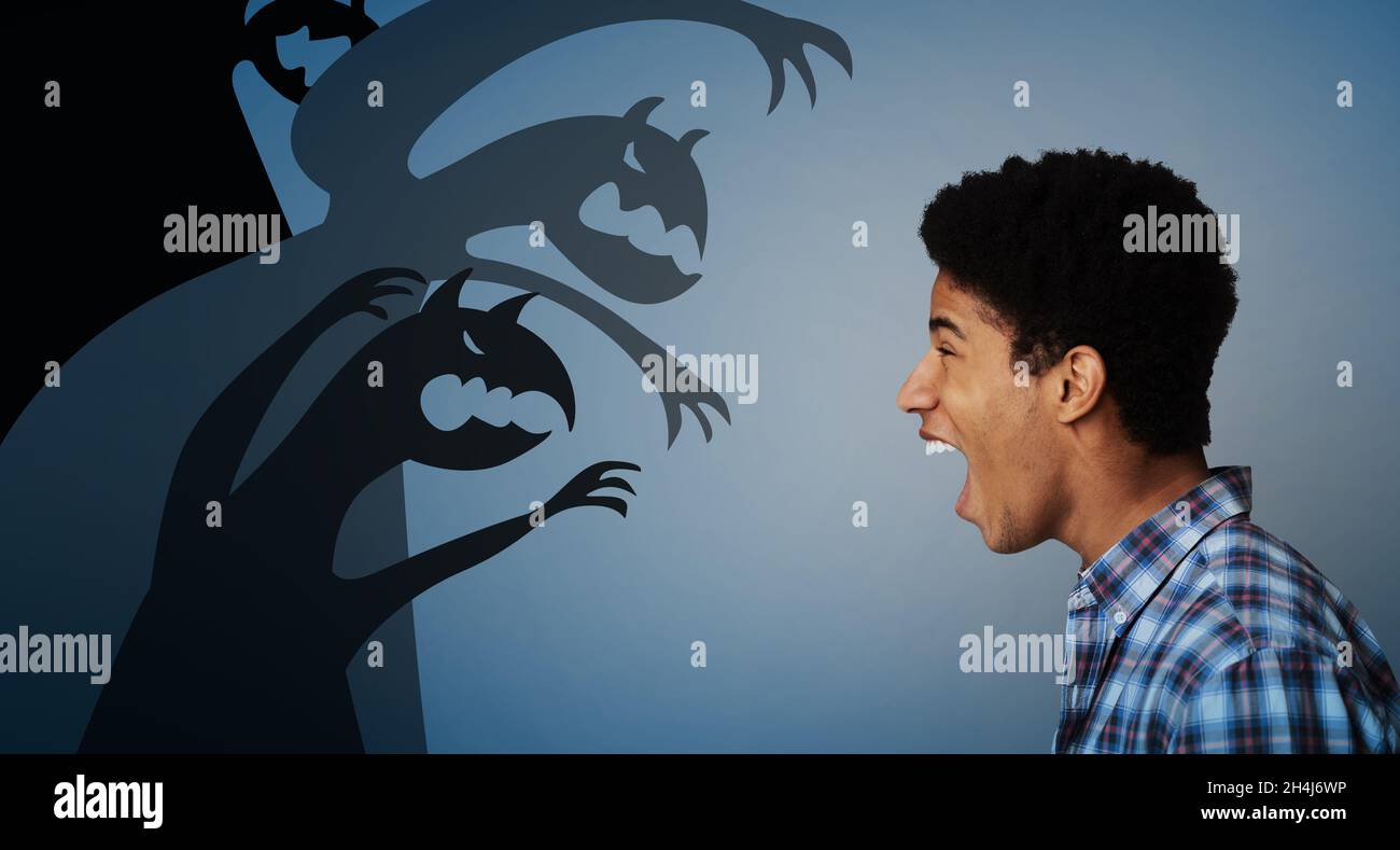 Side view of black teen guy screaming at scary monster silhouettes ...