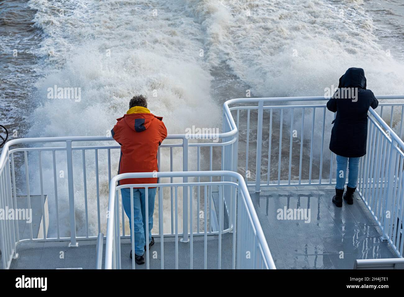 Passengers at the stern of Halunder Jet, River Elbe between Brunsbüttel ...