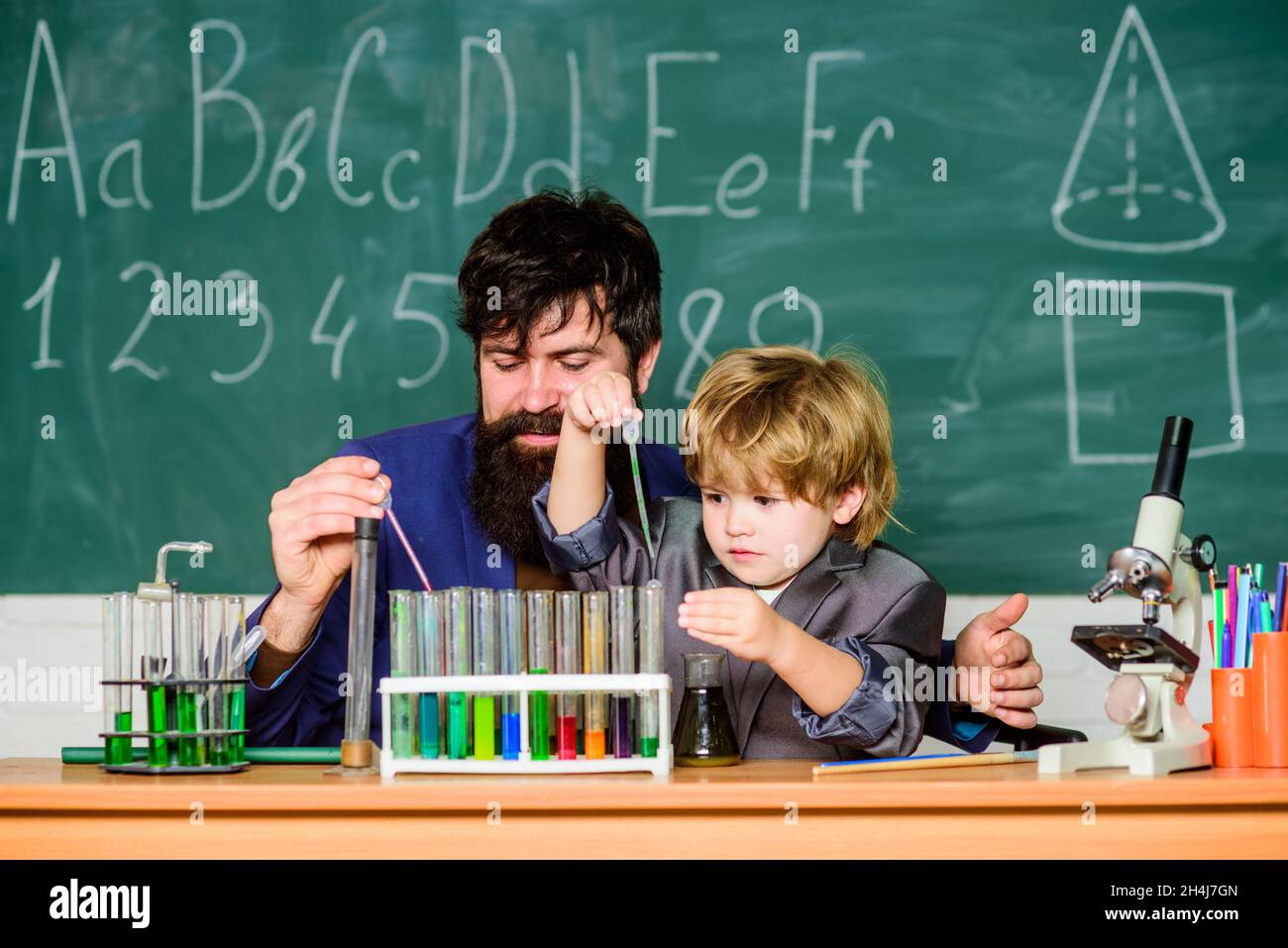 Know How. laboratory research and development. teacher man with little ...