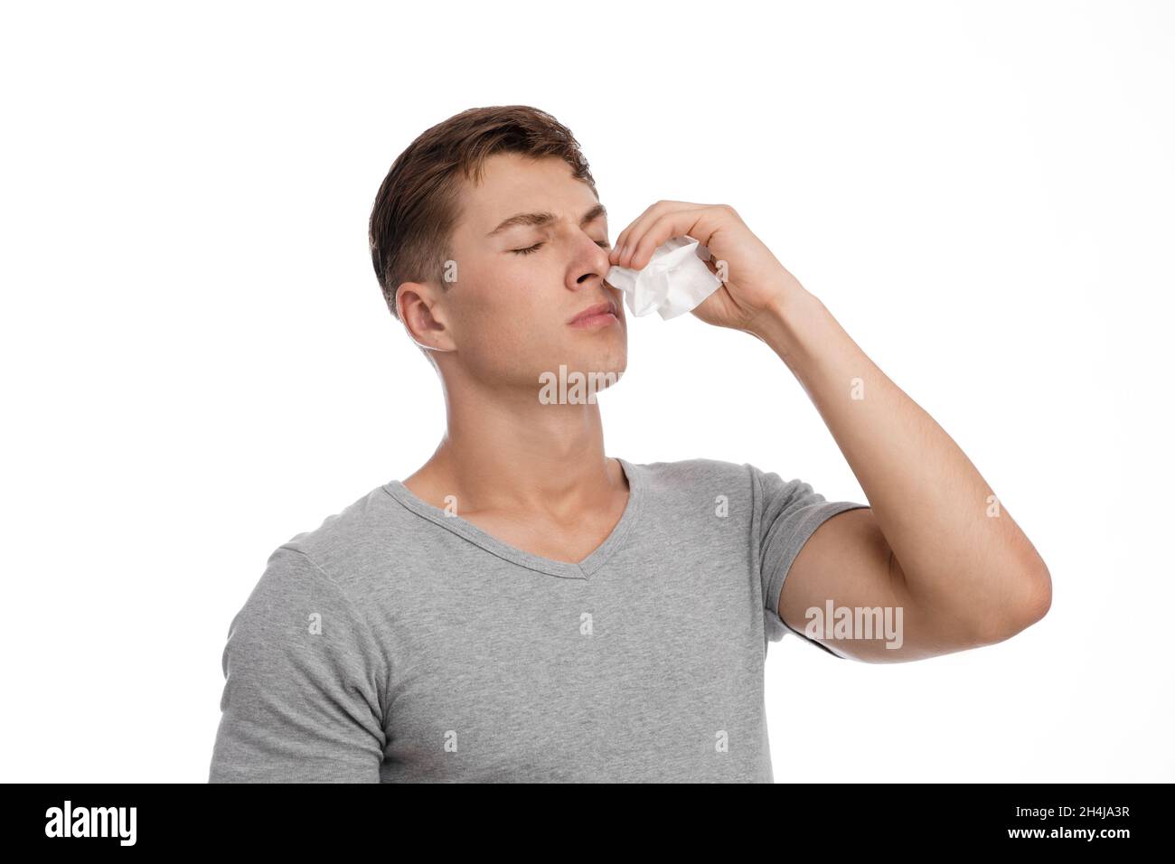 Disappointment sad young caucasian handsome guy presses napkin to nose ...