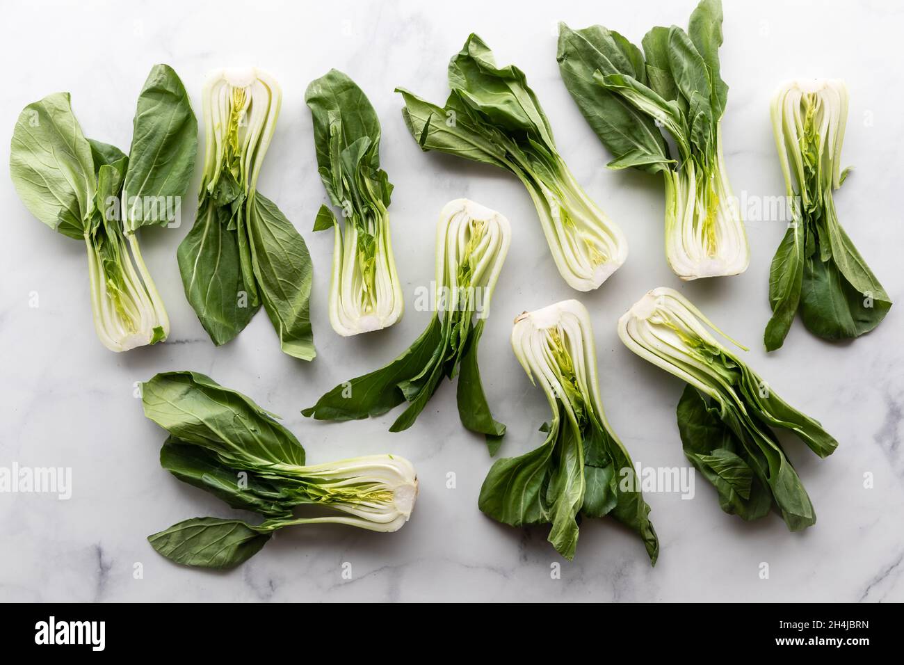 Fresh bok choy clusters scattered on a marble countertop Stock Photo ...