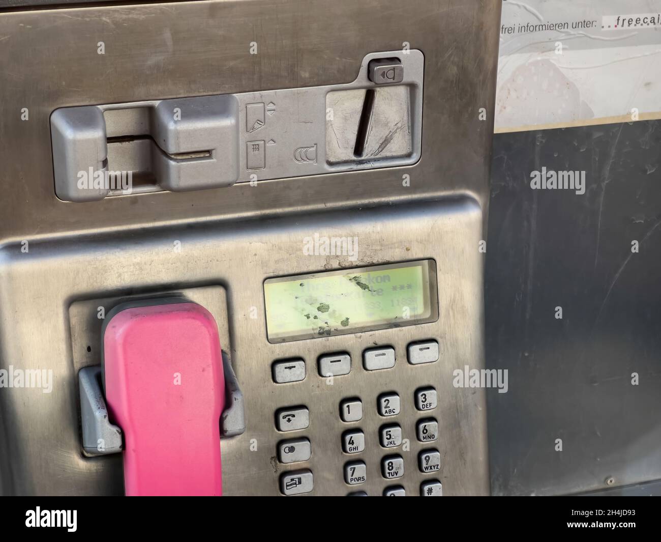 Close-up of Deutsche Telecom phone booth with old operated phone with ...