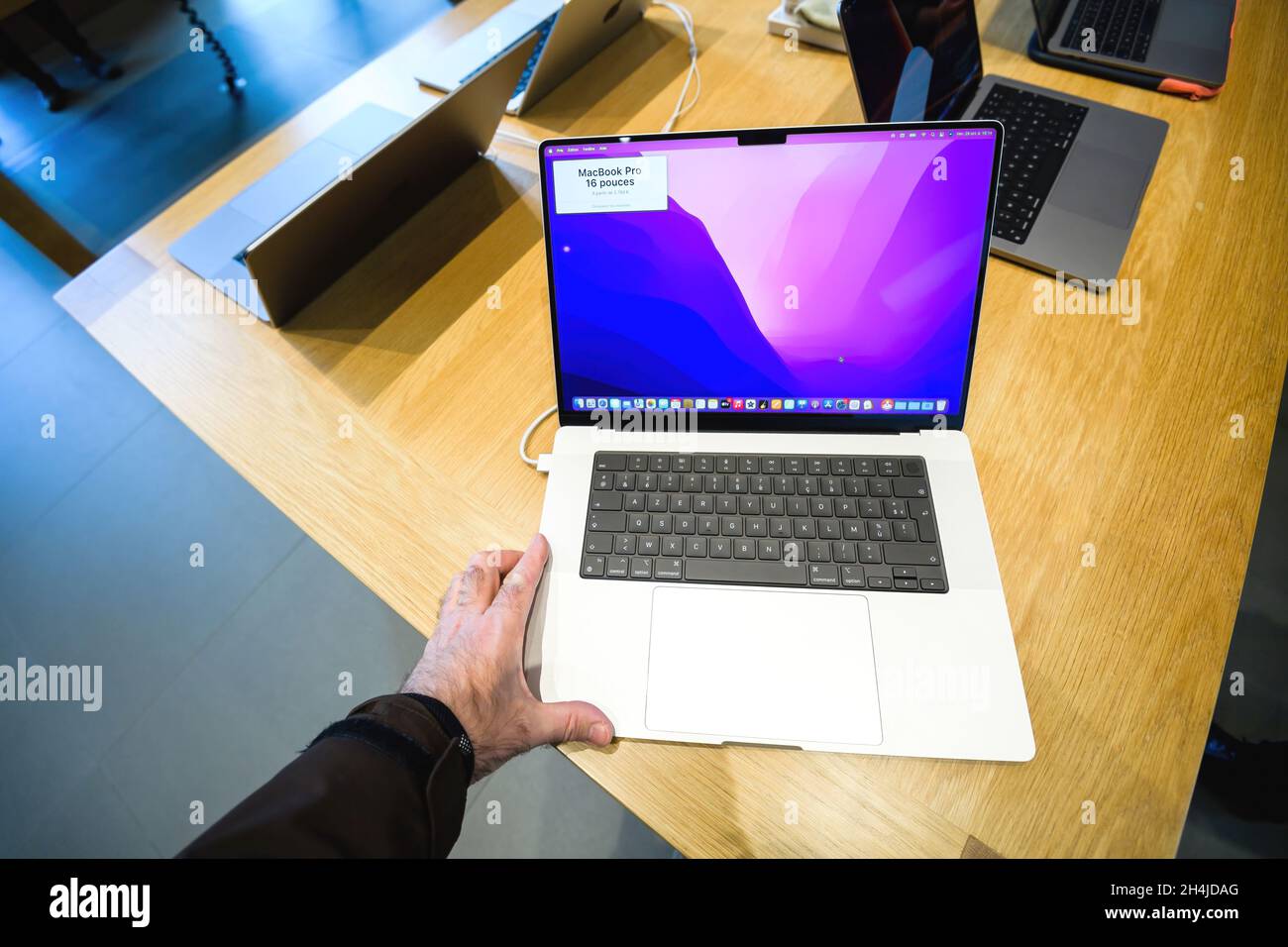 Male hand looking at the new Apple MacBook book pro 16 inch laptop ...