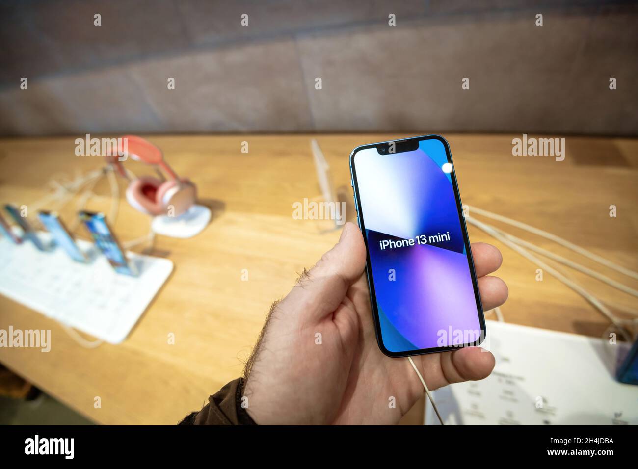 Male hand holding new iPhone 13 mini at the Apple Store Stock Photo - Alamy