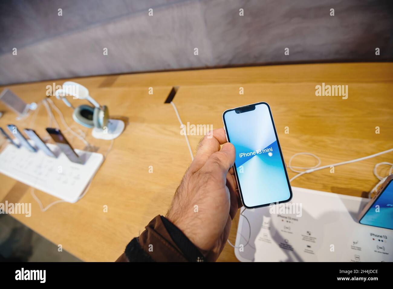 Male hand holding new iPhone 13 mini at the Apple Store Stock Photo - Alamy