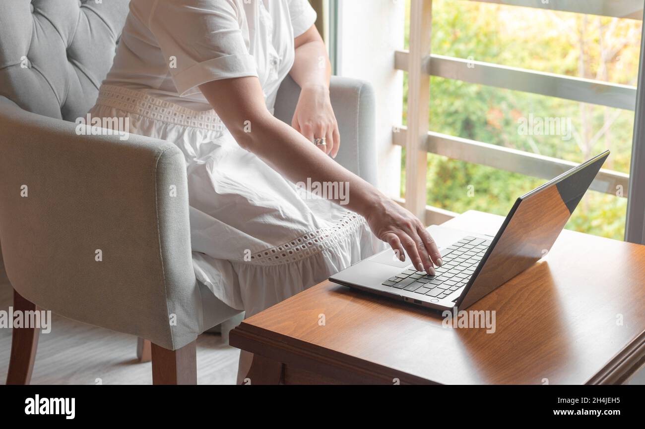Woman hands using computer laptop at home interior. unrecognizable ...
