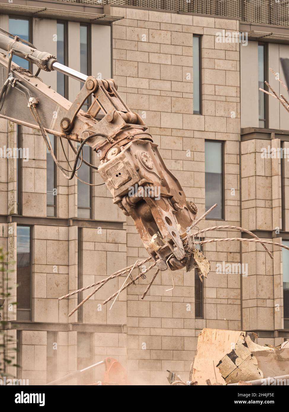 digger claw grabbing at concrete and steel bars on a demolition site ...