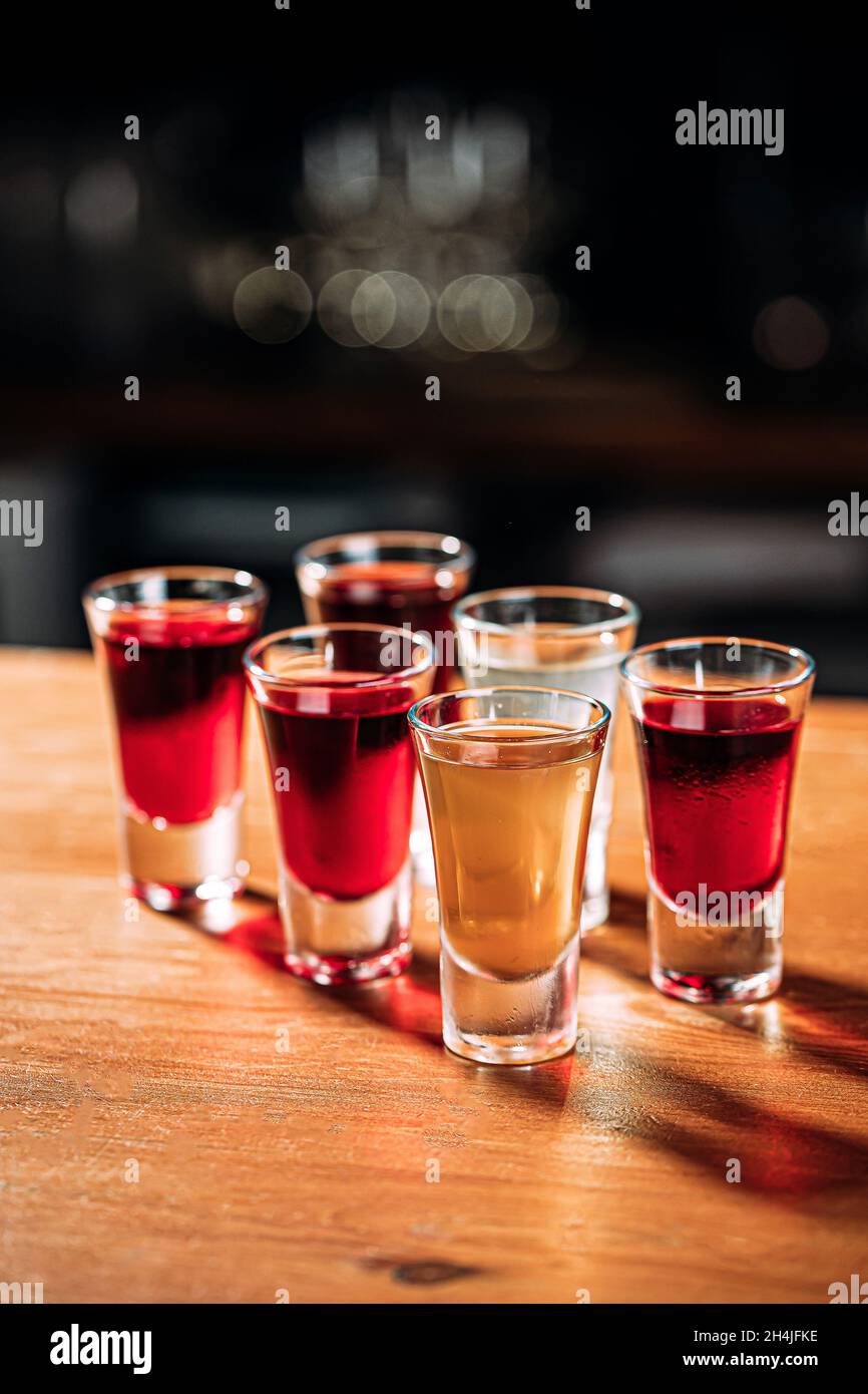 Various shot drinks on the wooden bar desk Stock Photo - Alamy