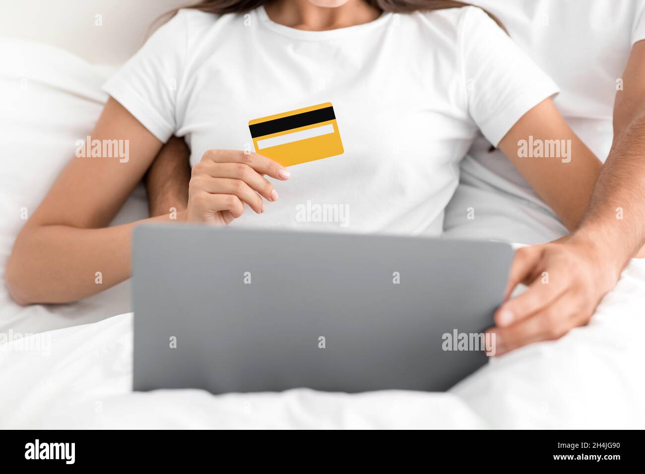 Caucasian millennial man hugs woman, lady holds credit card and orders ...