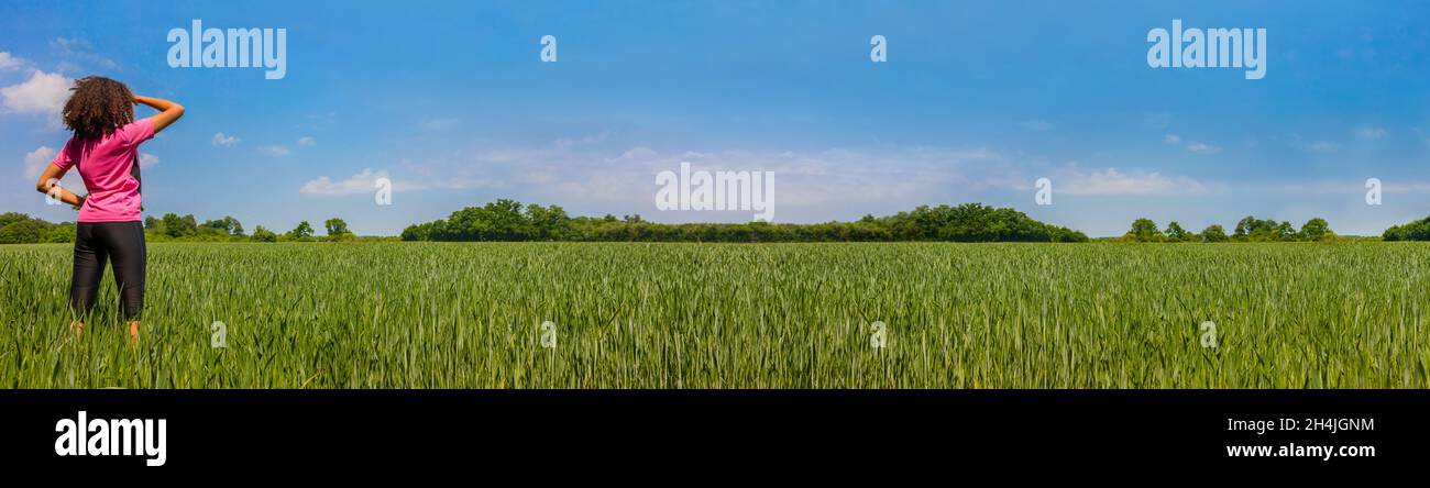 Rear view panoramic web banner of young woman girl female runner jogger running standing in ...