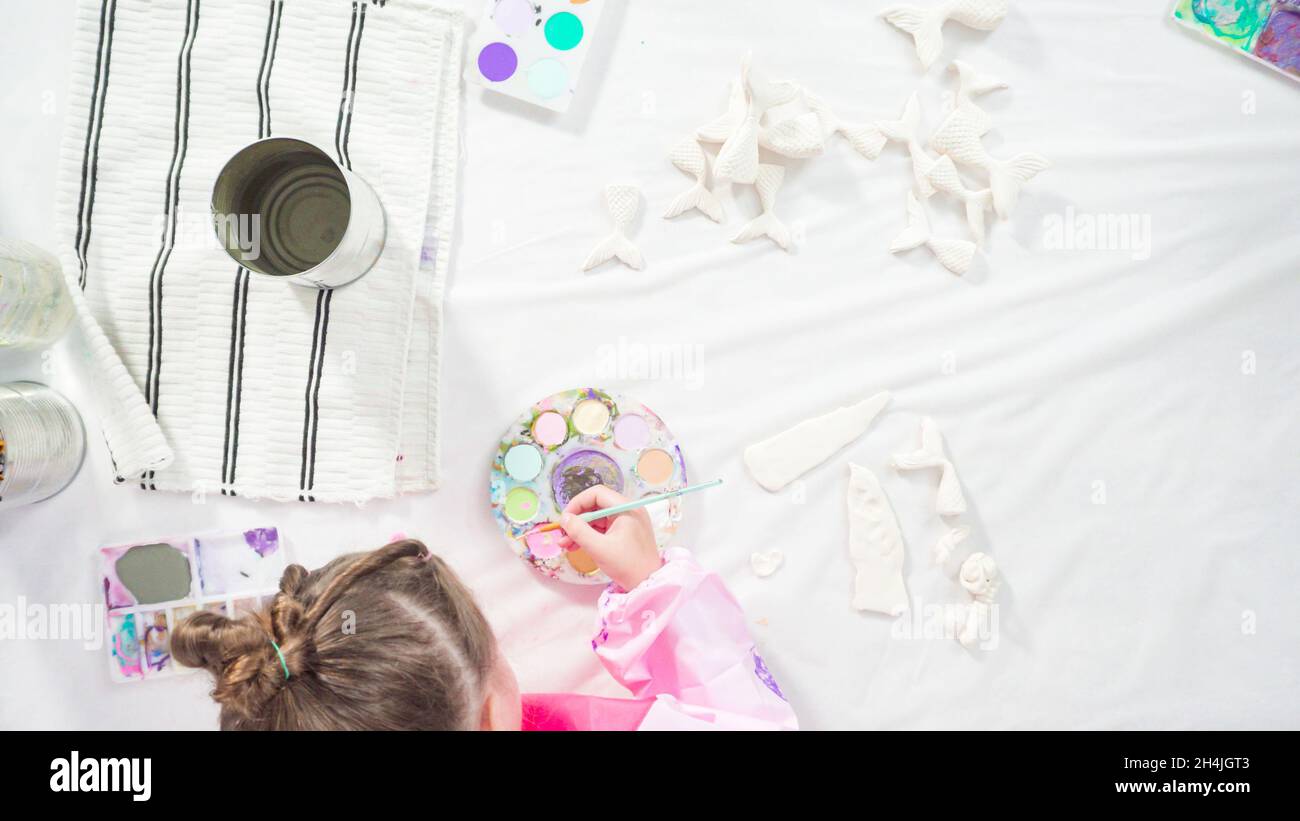 Flat lay. Step by step. Mother and daughter painting mermaid tails and ...