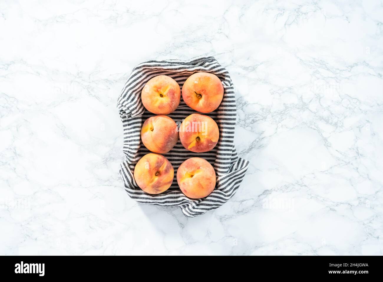 Organic whole peaches in a metal wired basket Stock Photo - Alamy