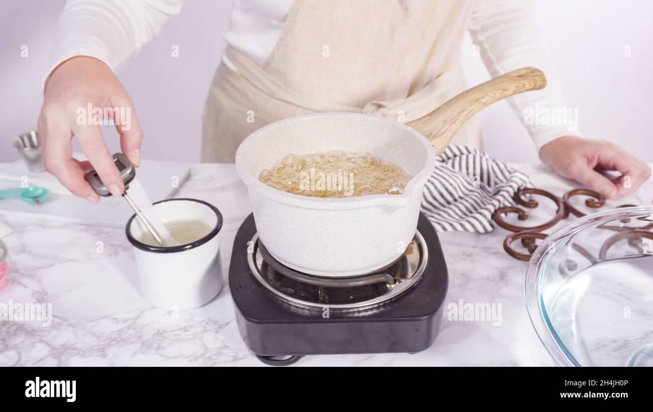 Step by step. Caramelizing sugar in a small cooking pot over the small ...