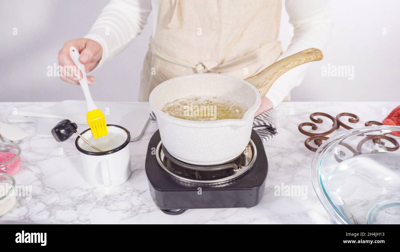 Step by step. Caramelizing sugar in a small cooking pot over the small ...