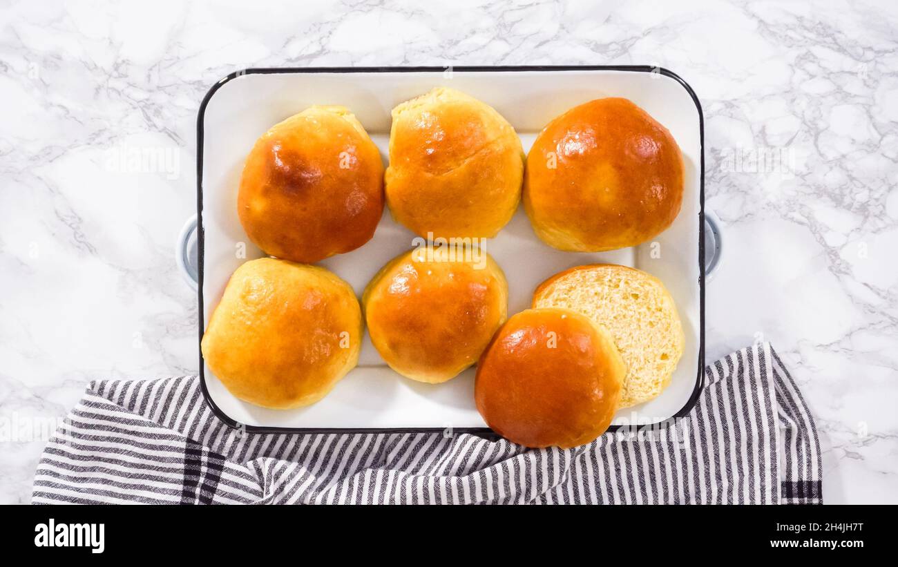 Flat lay. Step by step. Freshly baked brioche buns on a metal serving ...