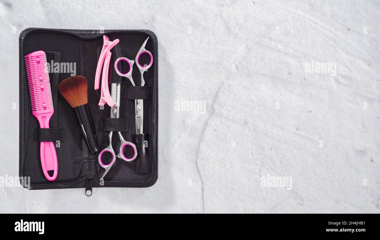 Flat lay. Pink hair cutting scissors set Stock Photo - Alamy