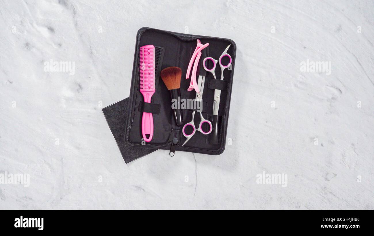 Flat lay. Pink hair cutting scissors set Stock Photo - Alamy