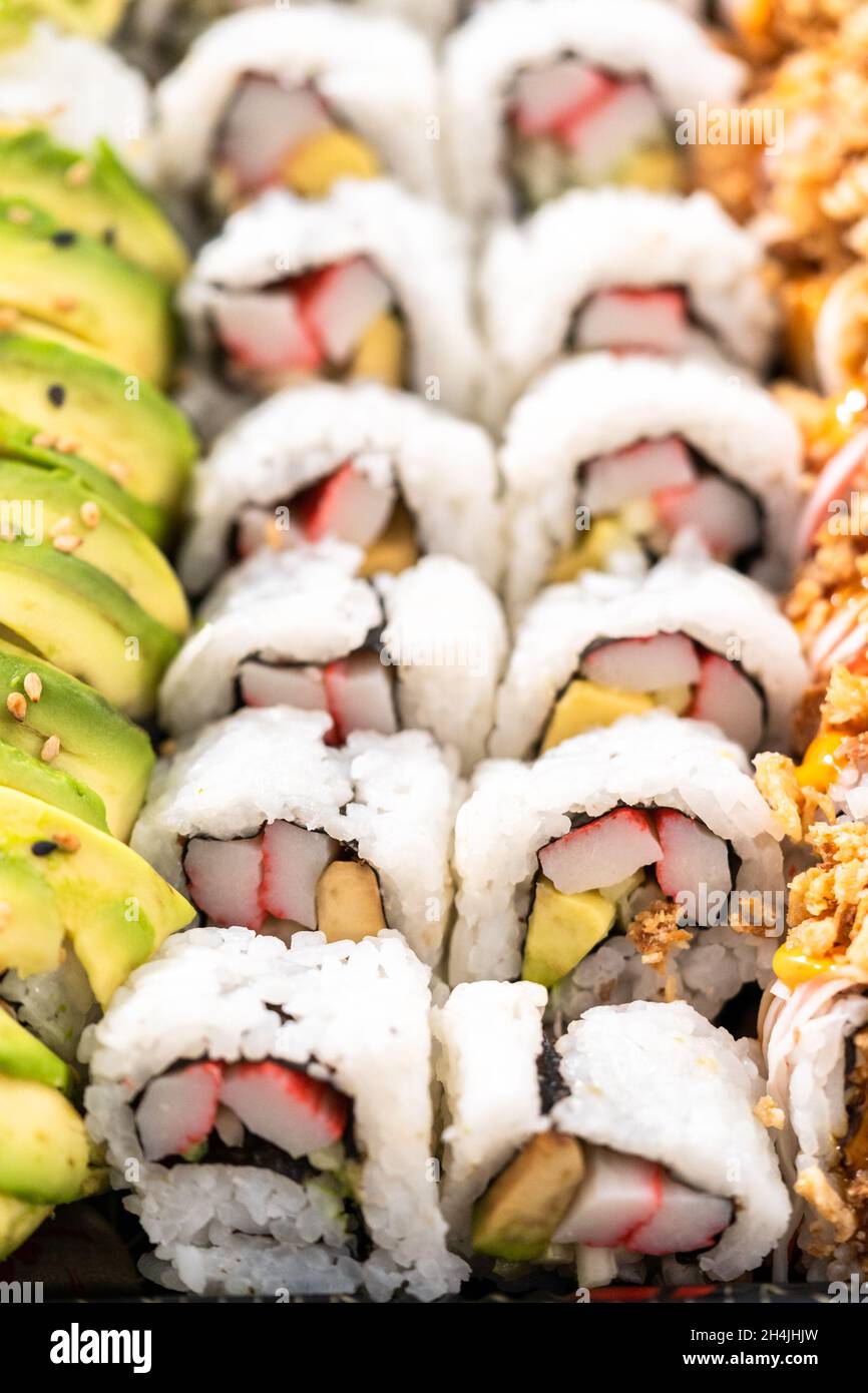Pre-packaged variety of sushi and sushi rolls in a plastic tray Stock ...