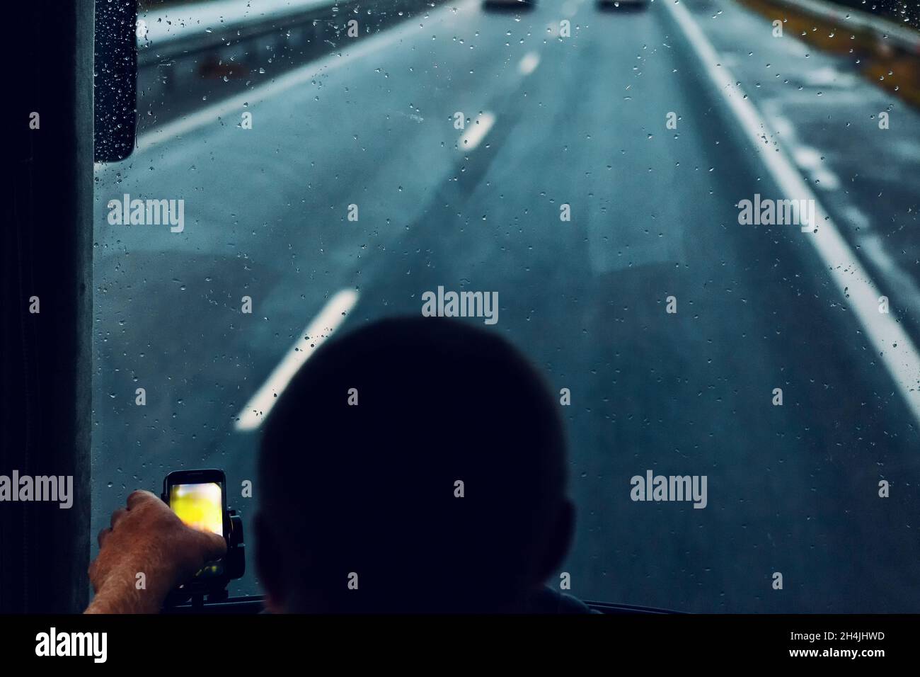 Driving in the rainy night . Rear view of driver . Raindrops on the ...