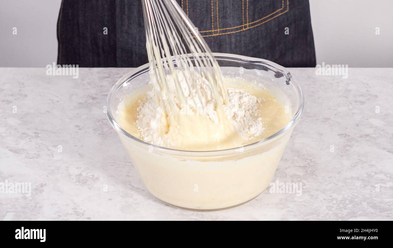 Step by step. Mixing ingredients in a glass mixing bowl to prepare ...
