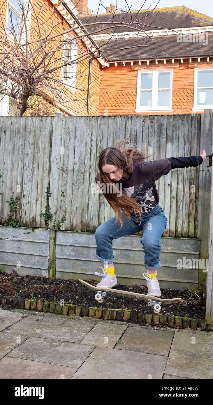 Teenage girl, jumping on a skateboard Stock Photo - Alamy