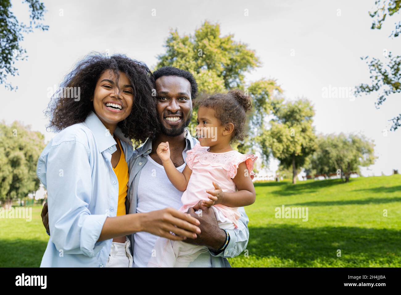 Beautiful happy african american family bonding at the park - Black ...