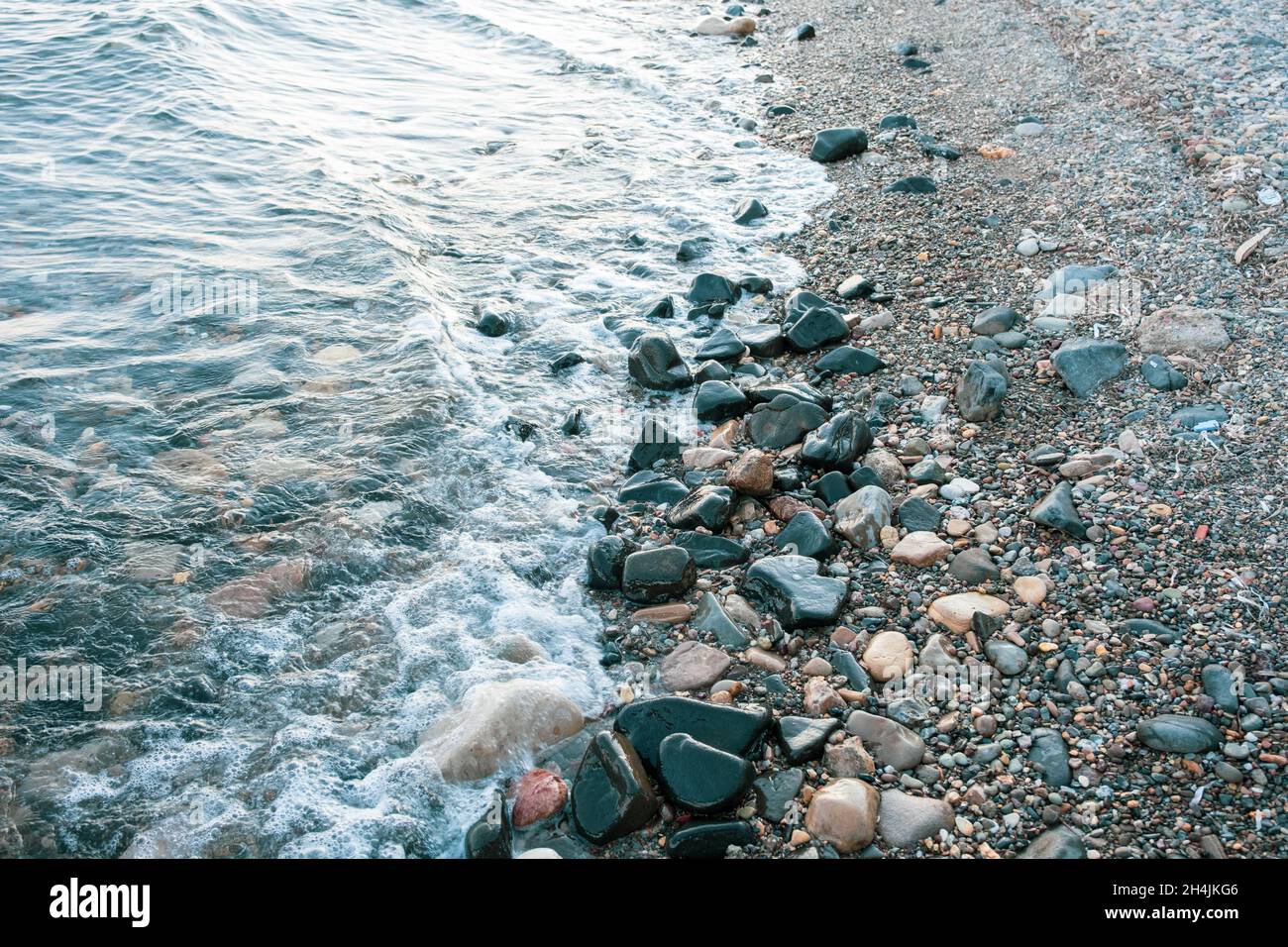 waves hitting the rocks on the beach Stock Photo - Alamy