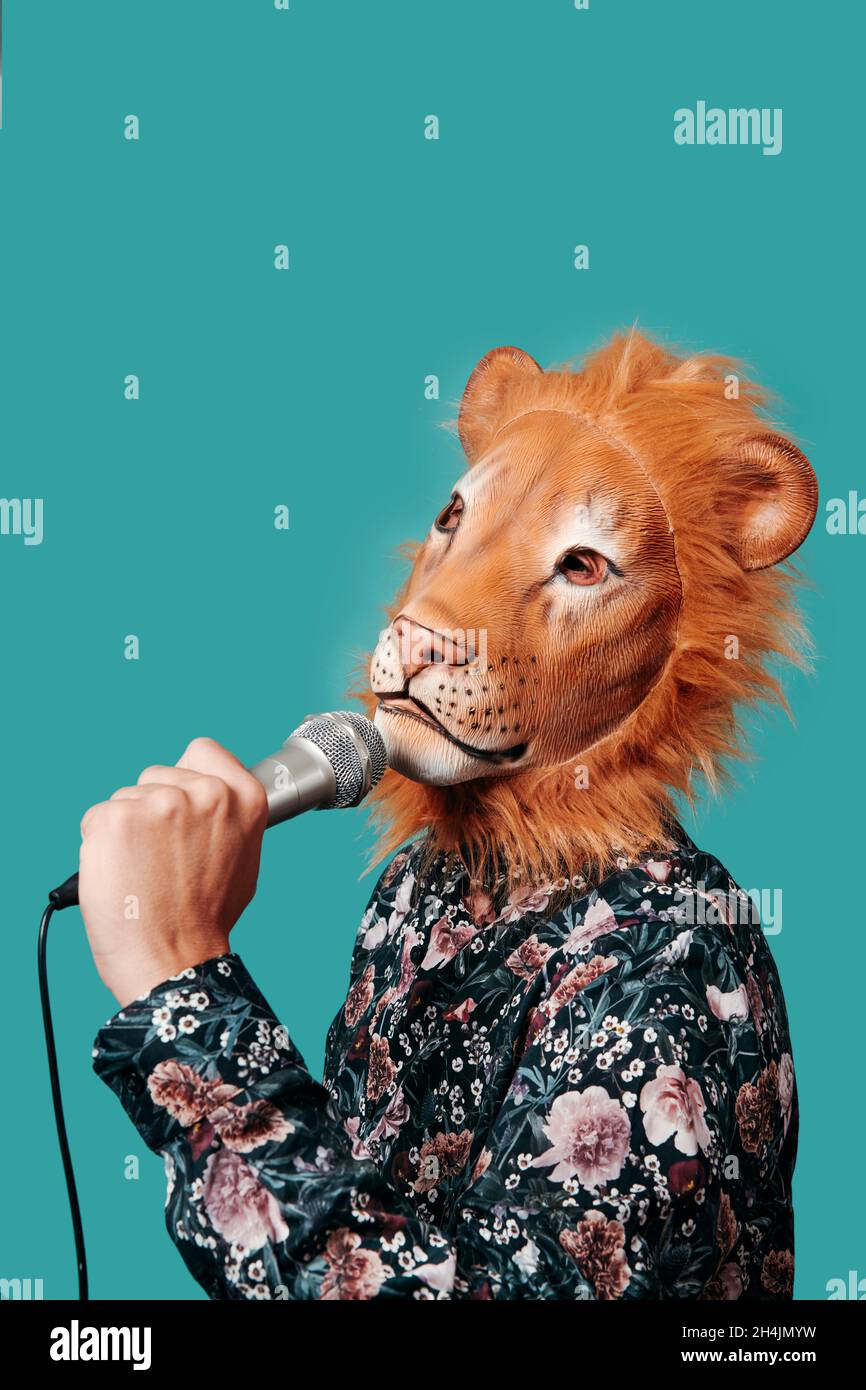 closeup of a man using a microphone while is wearing a lion mask in ...
