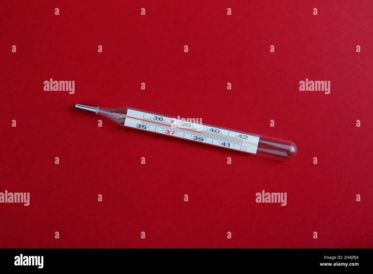 Medical device thermometer isolated on a red background. High ...