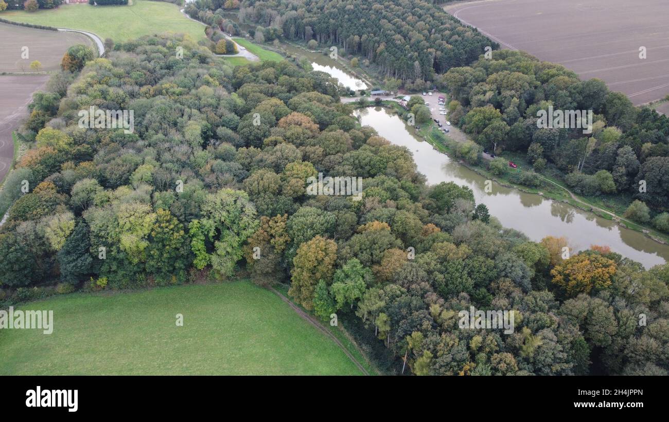 Aerial View of Lake Nested Between Woodland Forest Trees in Countryside ...