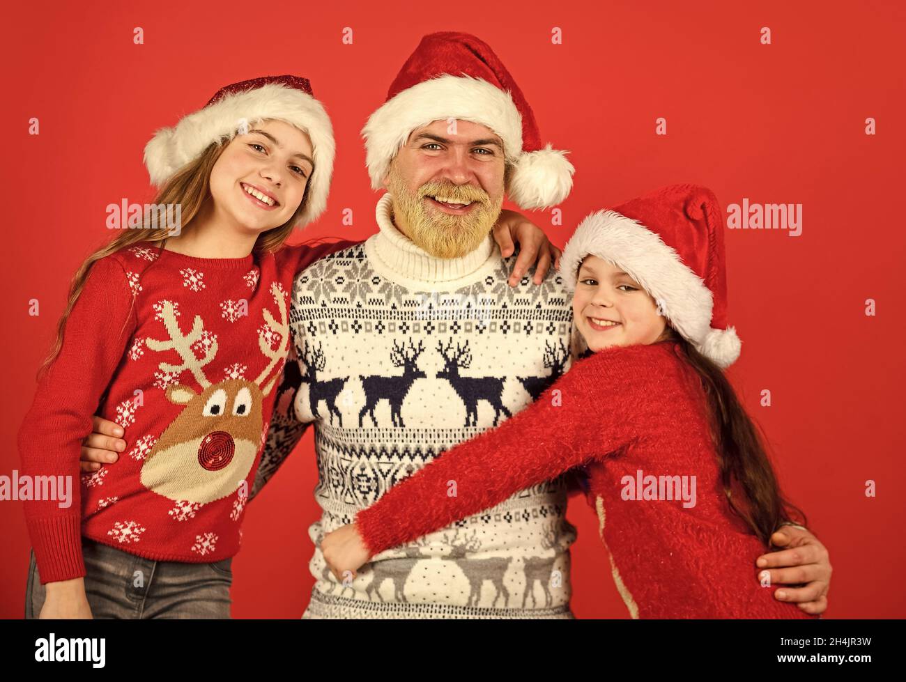 Happy Holidays. small girls love their father. dad embrace daughters ...